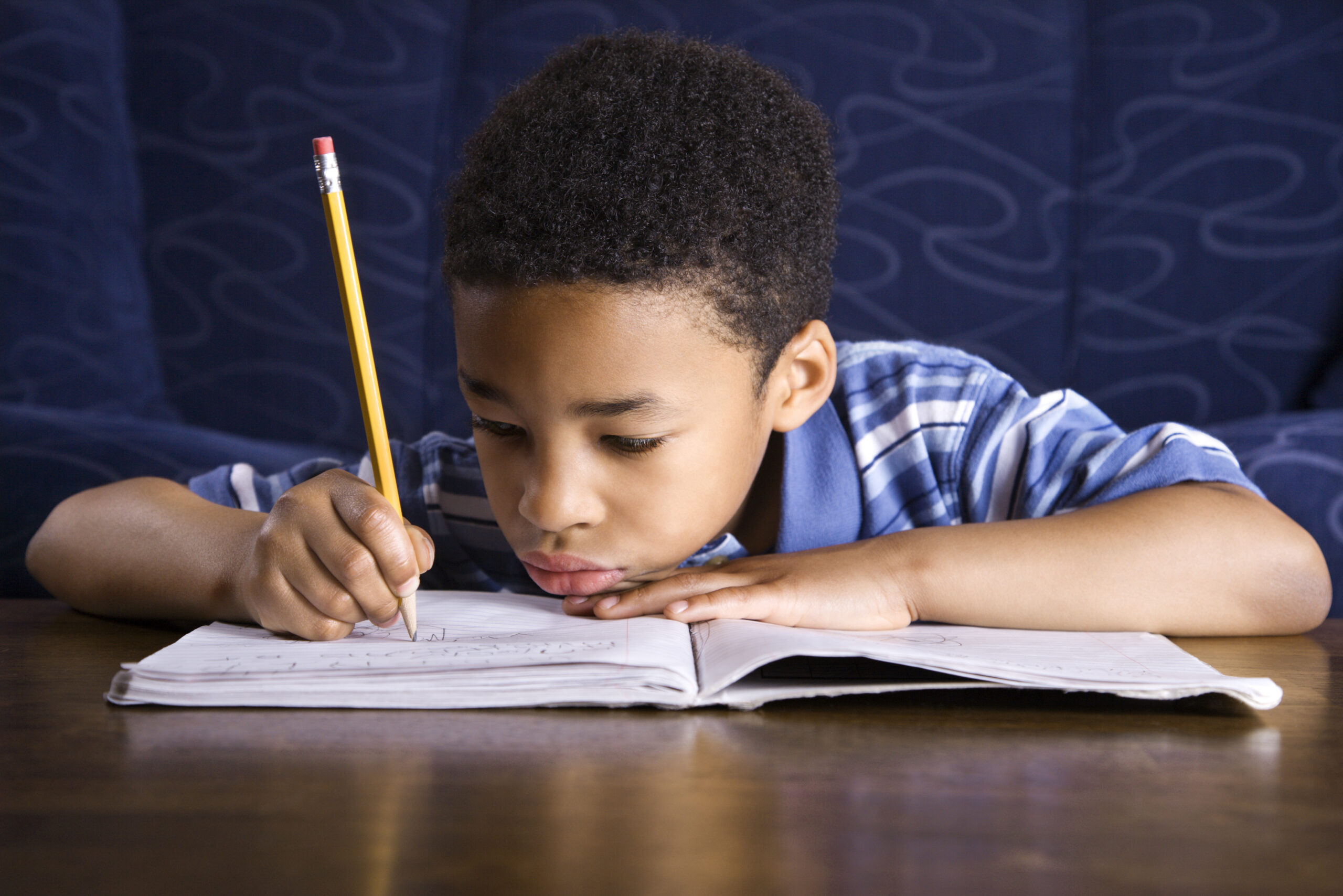 Boy Writing A Scary Story - Keep ‘em Thinking